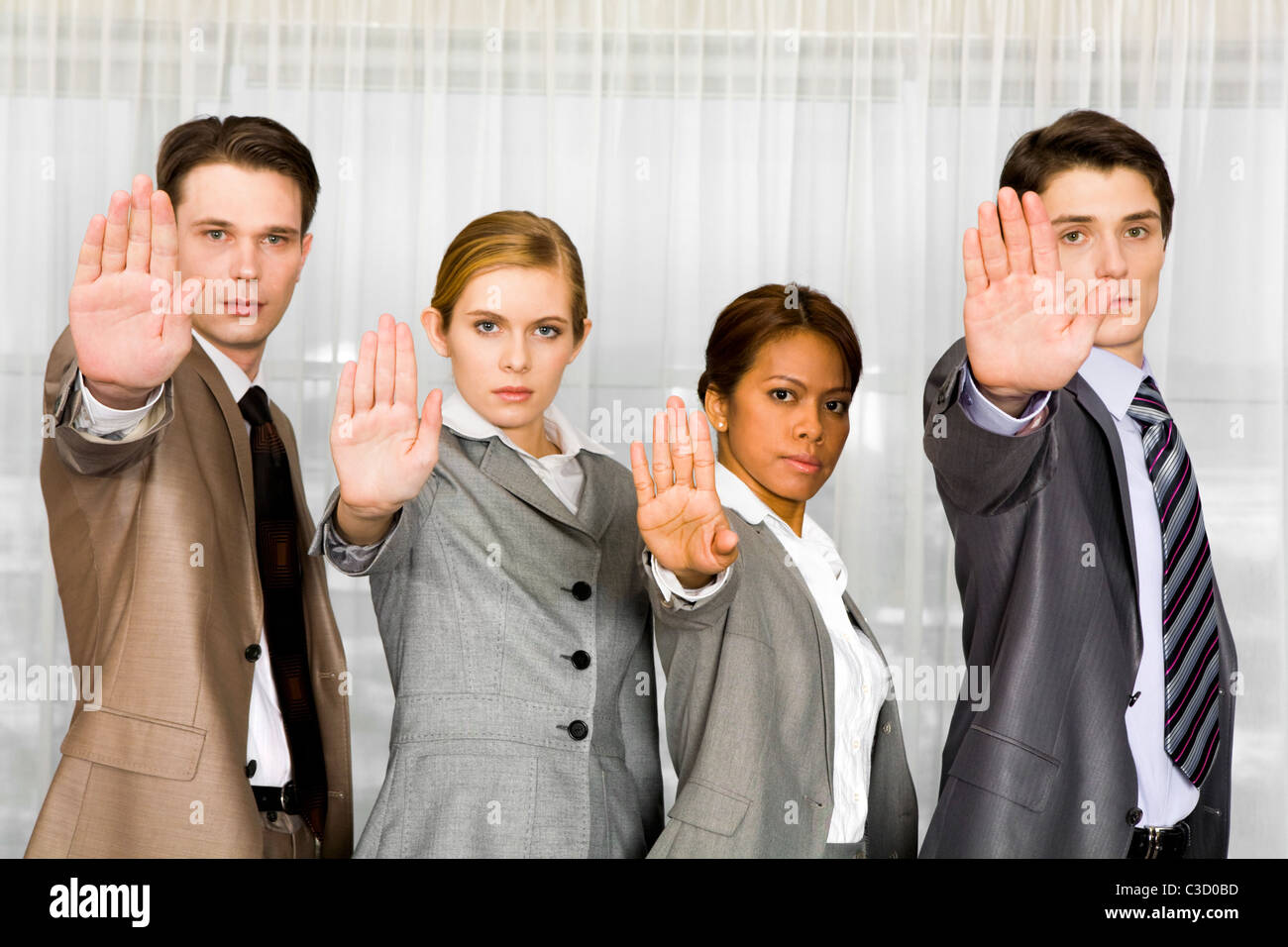 Photo of business people standing in line and showing stop sign by ...