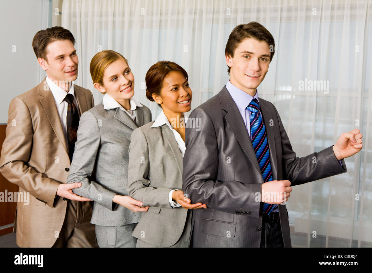 Contemporary business people standing in line and keeping their hands ...