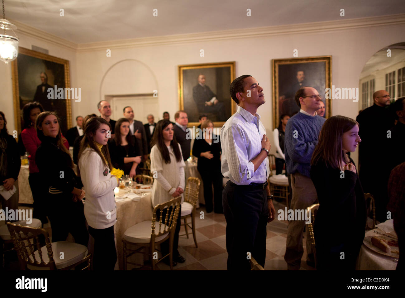 US President Barack Obama with his hand on his heart as the National ...