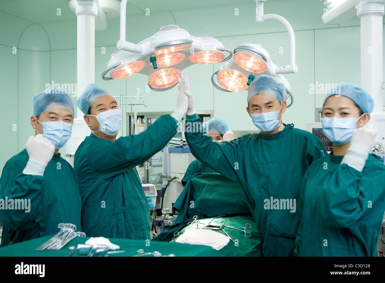 Team of surgeons celebrating success Stock Photo - Alamy
