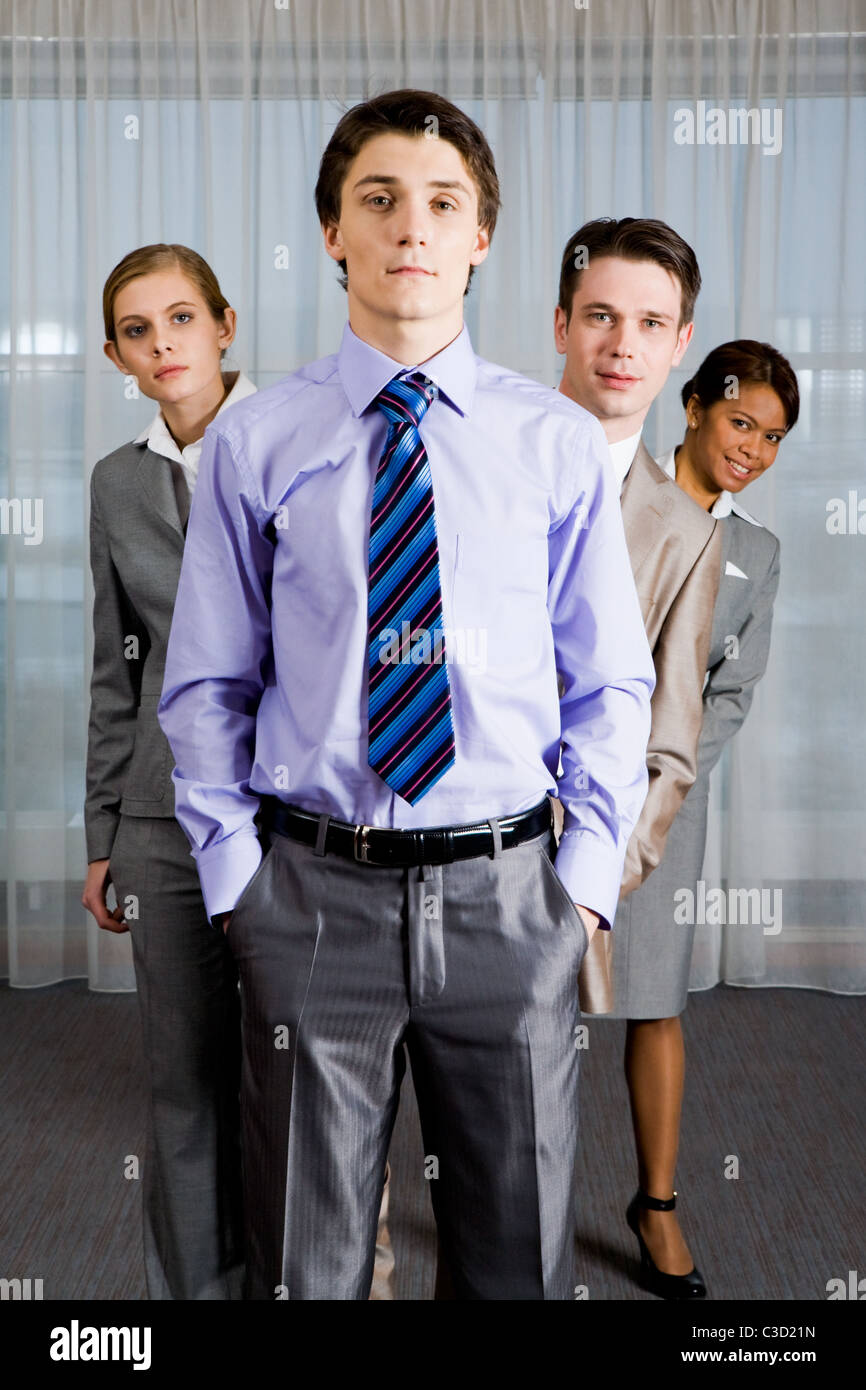 Photo of confident leader with several employees looking out of his ...