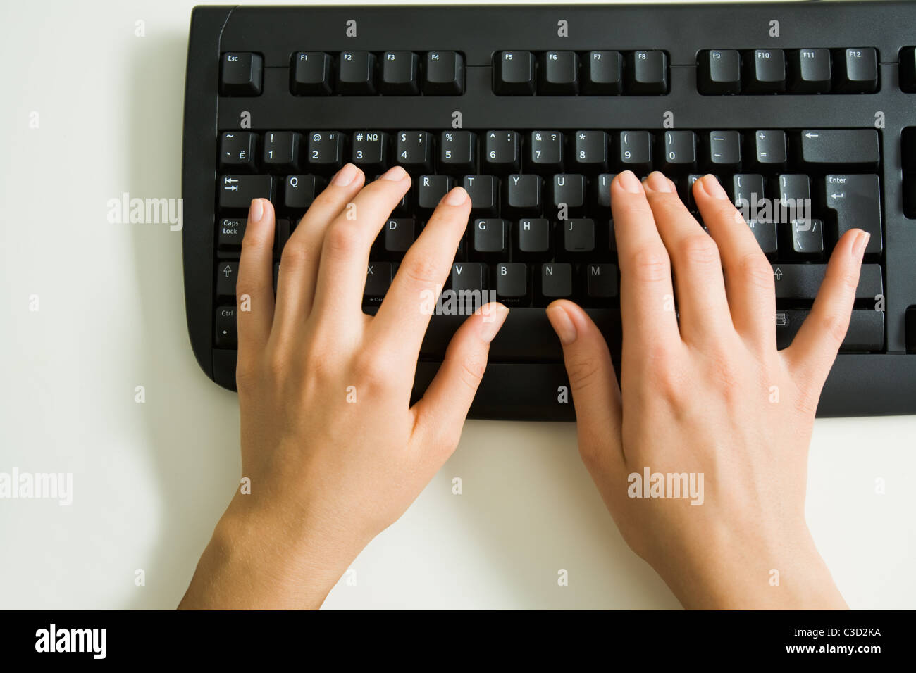 Above view of female hands typing documents or networking Stock Photo ...