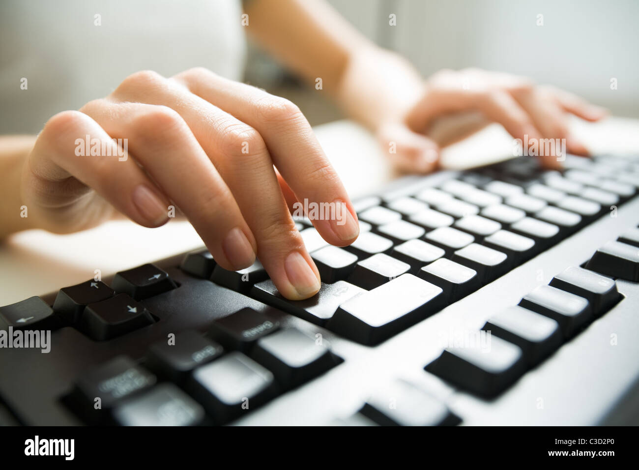Close-up of female hands pressing enter key on black keyboard Stock ...