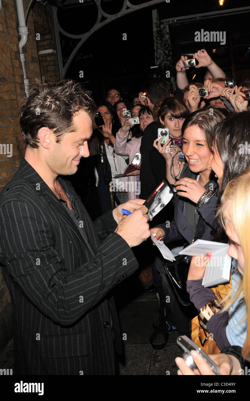 Jude Law signs autographs for waiting fans as he leaves the Wyndham's ...
