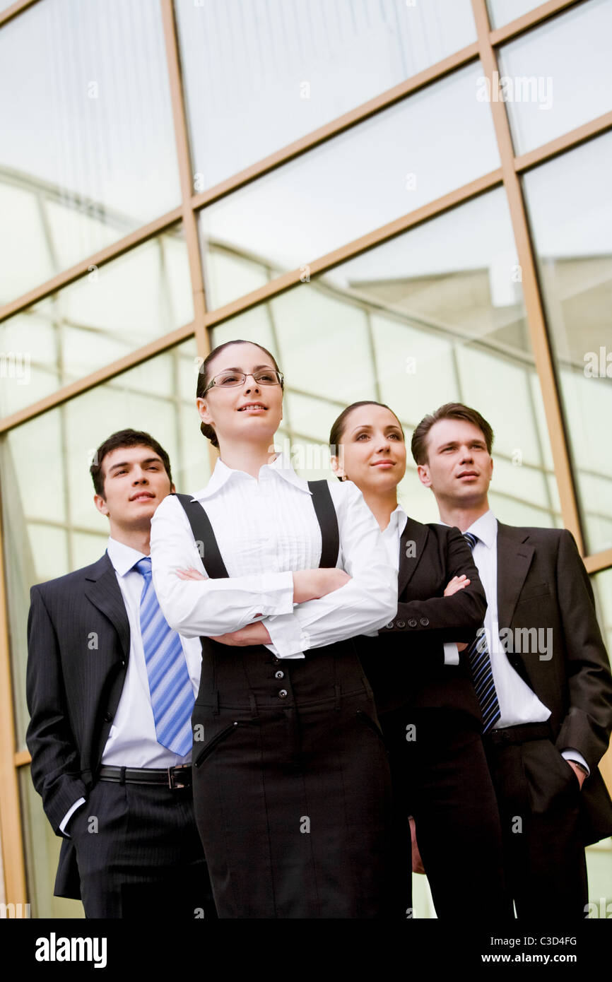 Several business leaders standing in row and looking forwards with ...