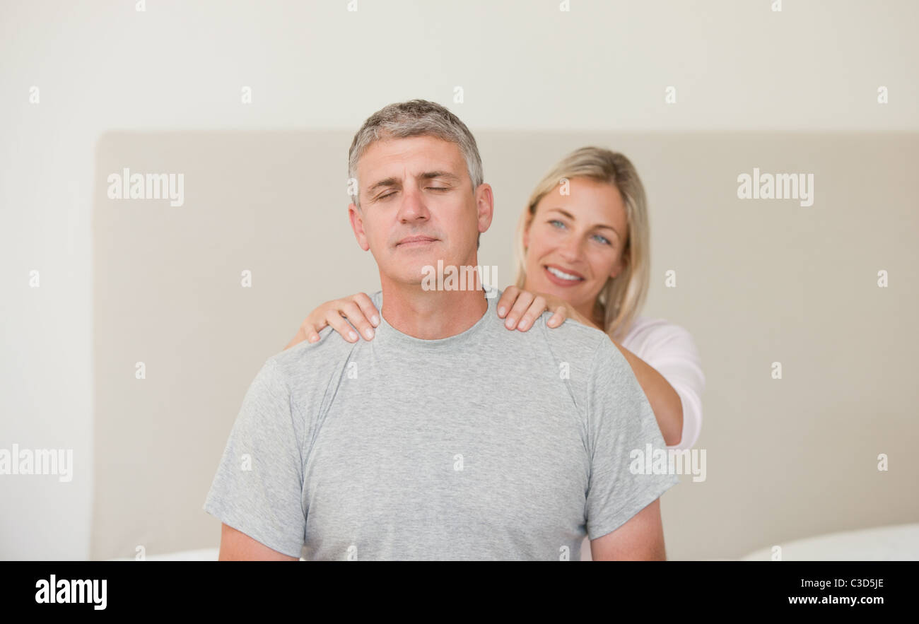 Woman giving a massage to her husband Stock Photo - Alamy