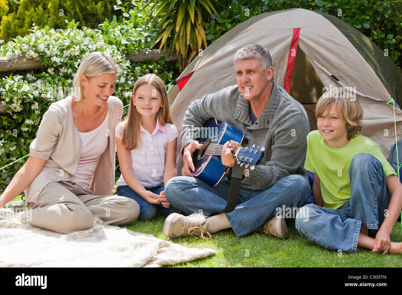 Happy family camping in the garden Stock Photo - Alamy