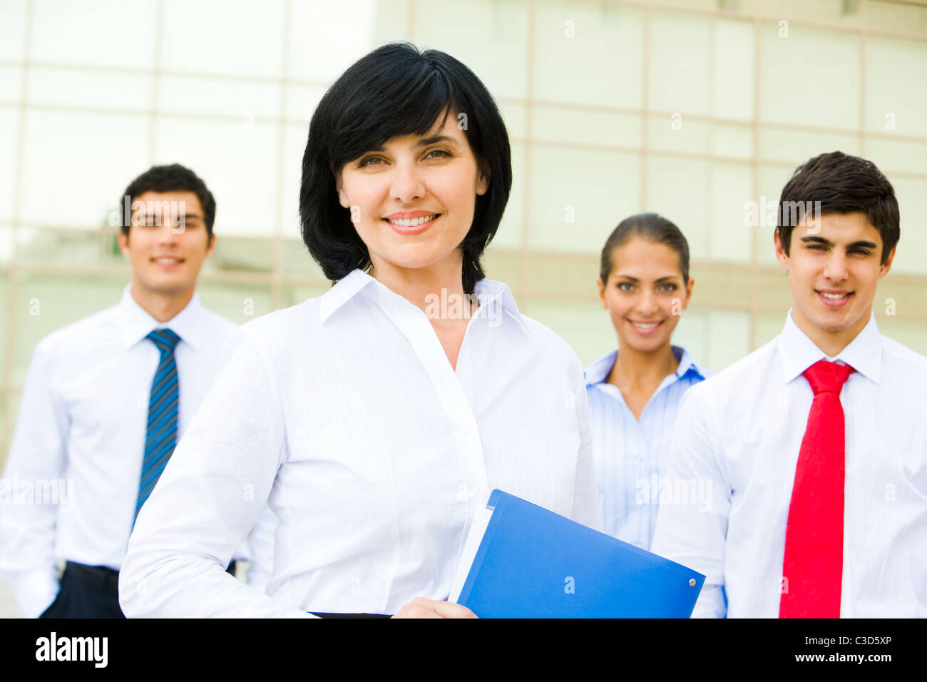 Portrait of attractive leader of friendly business group standing at ...