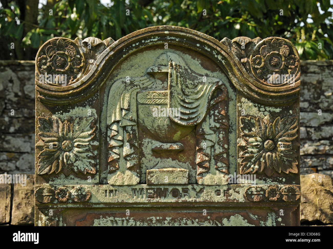 Detail of gravestone with draped urn and stylized floral design. Church ...