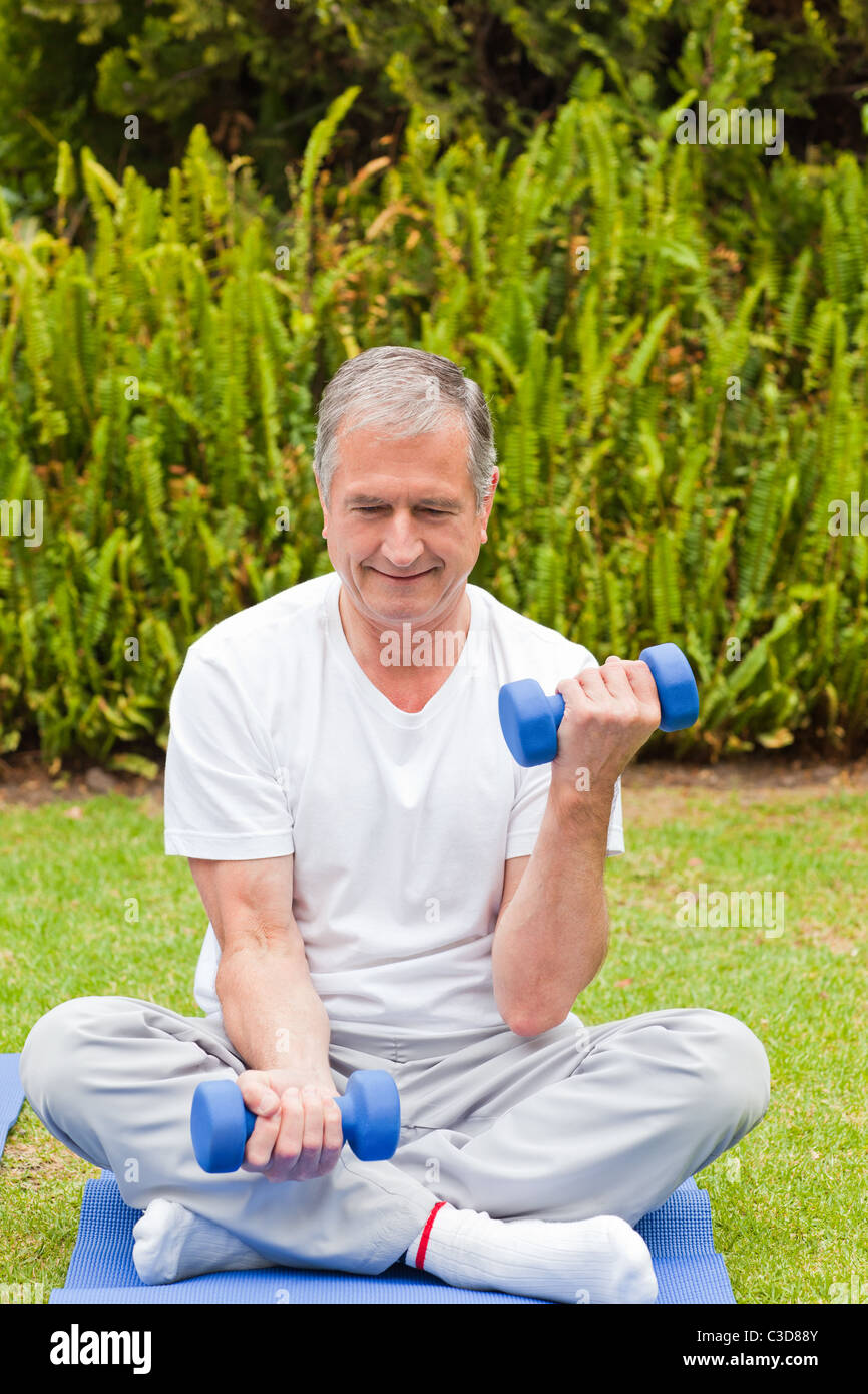 Retired man doing his exercises in the garden Stock Photo - Alamy