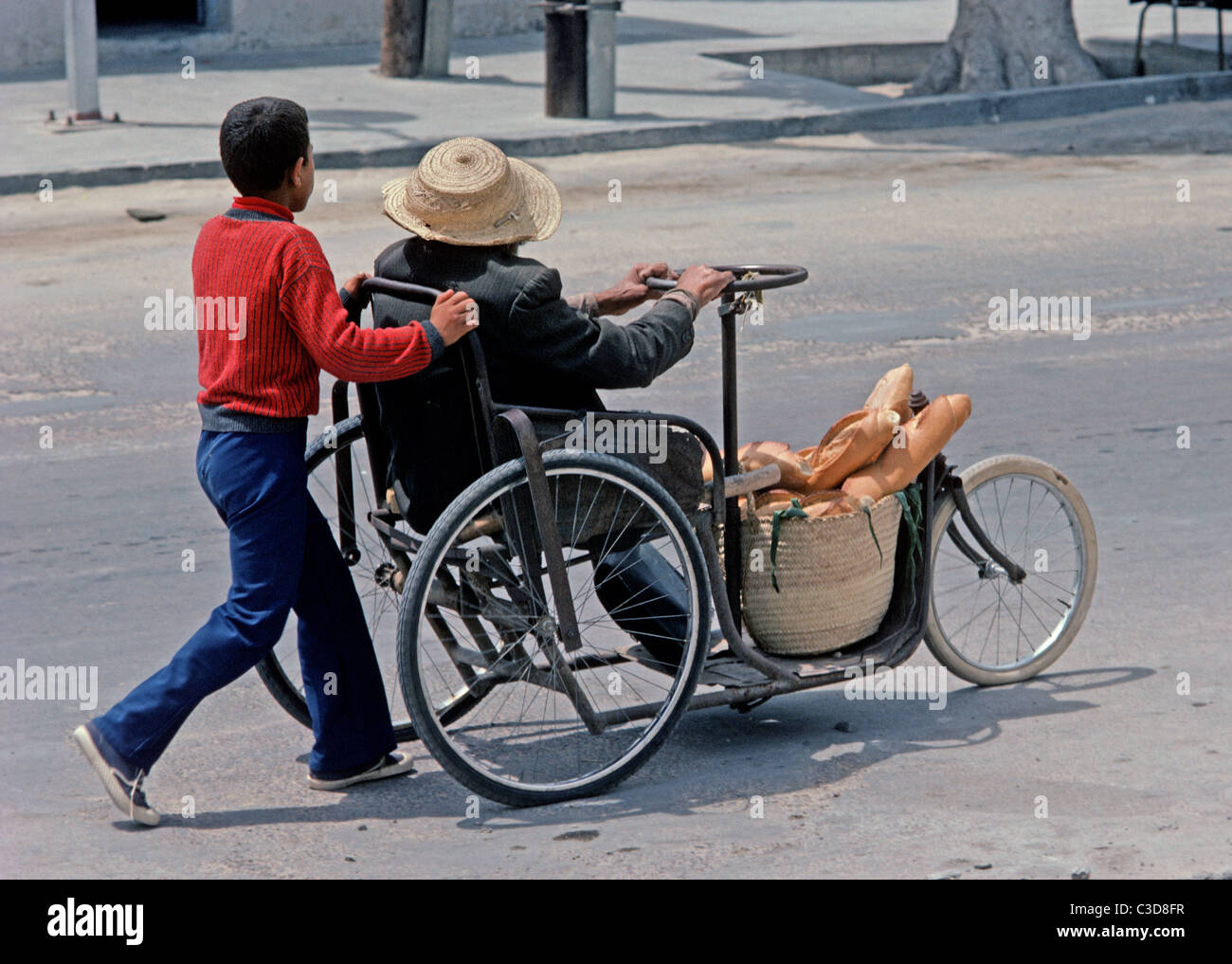 Boy pushing disabled man hi-res stock photography and images - Alamy
