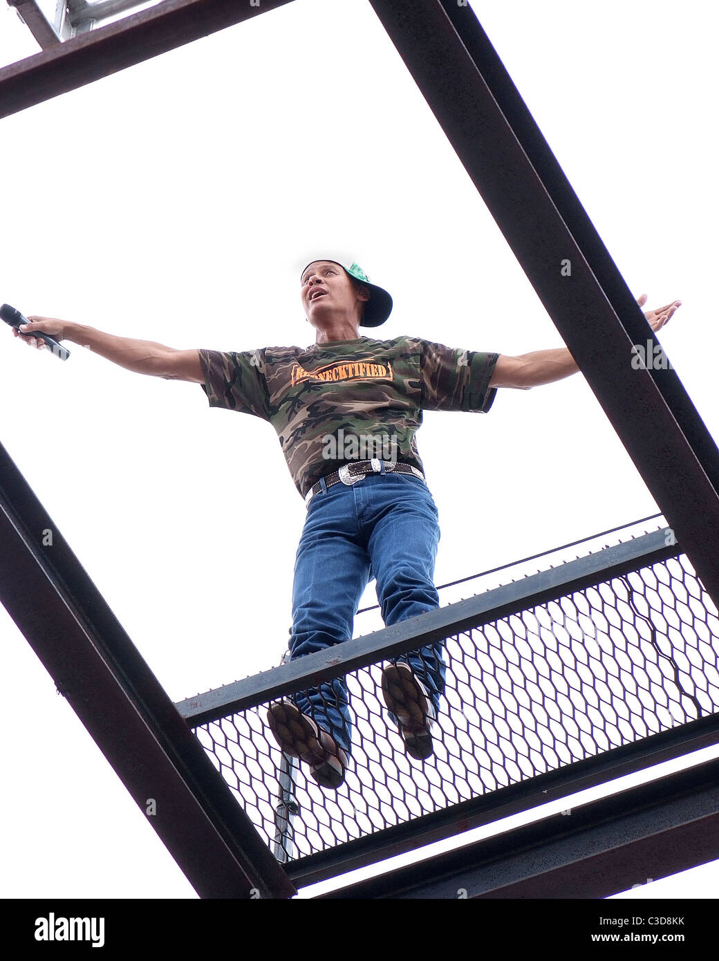 Country music singer Neal McCoy sings from atop a speaker tower ...