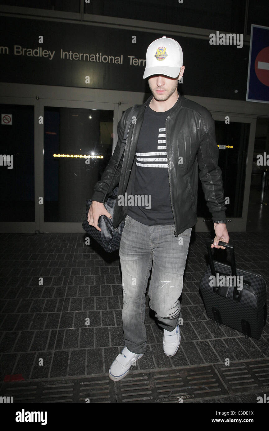 Justin Timberlake carrying his matching Louis Vuitton luggage as he ...