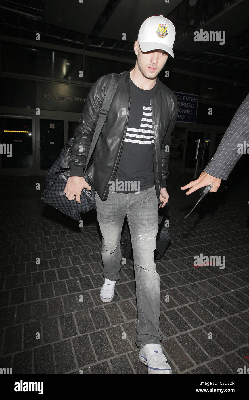 Justin Timberlake carrying his matching Louis Vuitton luggage as he ...