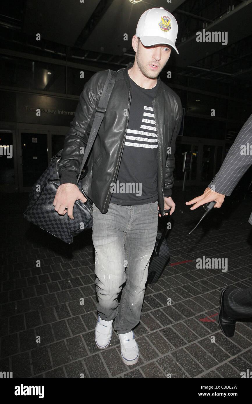 Justin Timberlake carrying his matching Louis Vuitton luggage as he ...