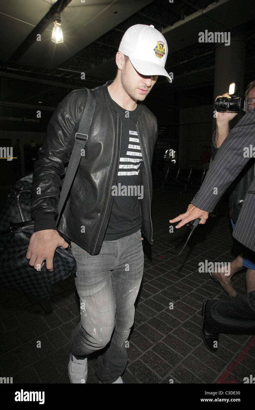 Justin Timberlake carrying his matching Louis Vuitton luggage as he ...