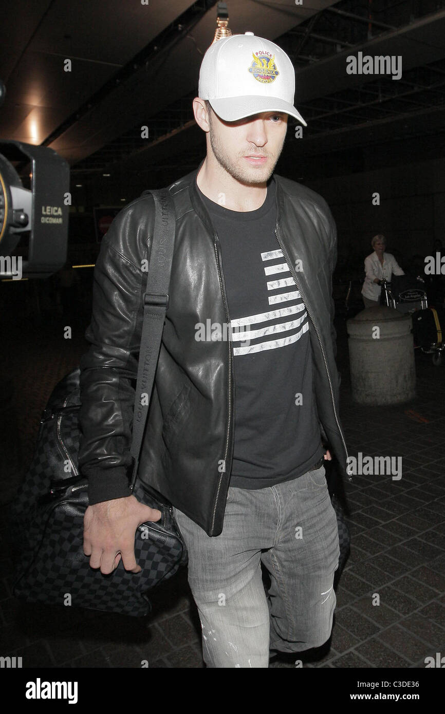 Justin Timberlake carrying his matching Louis Vuitton luggage as he ...