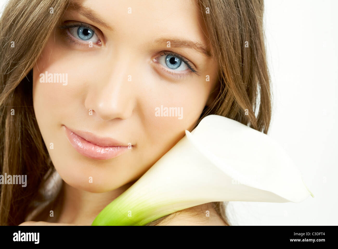 Face of beautiful girl with calla by her face looking at camera Stock ...