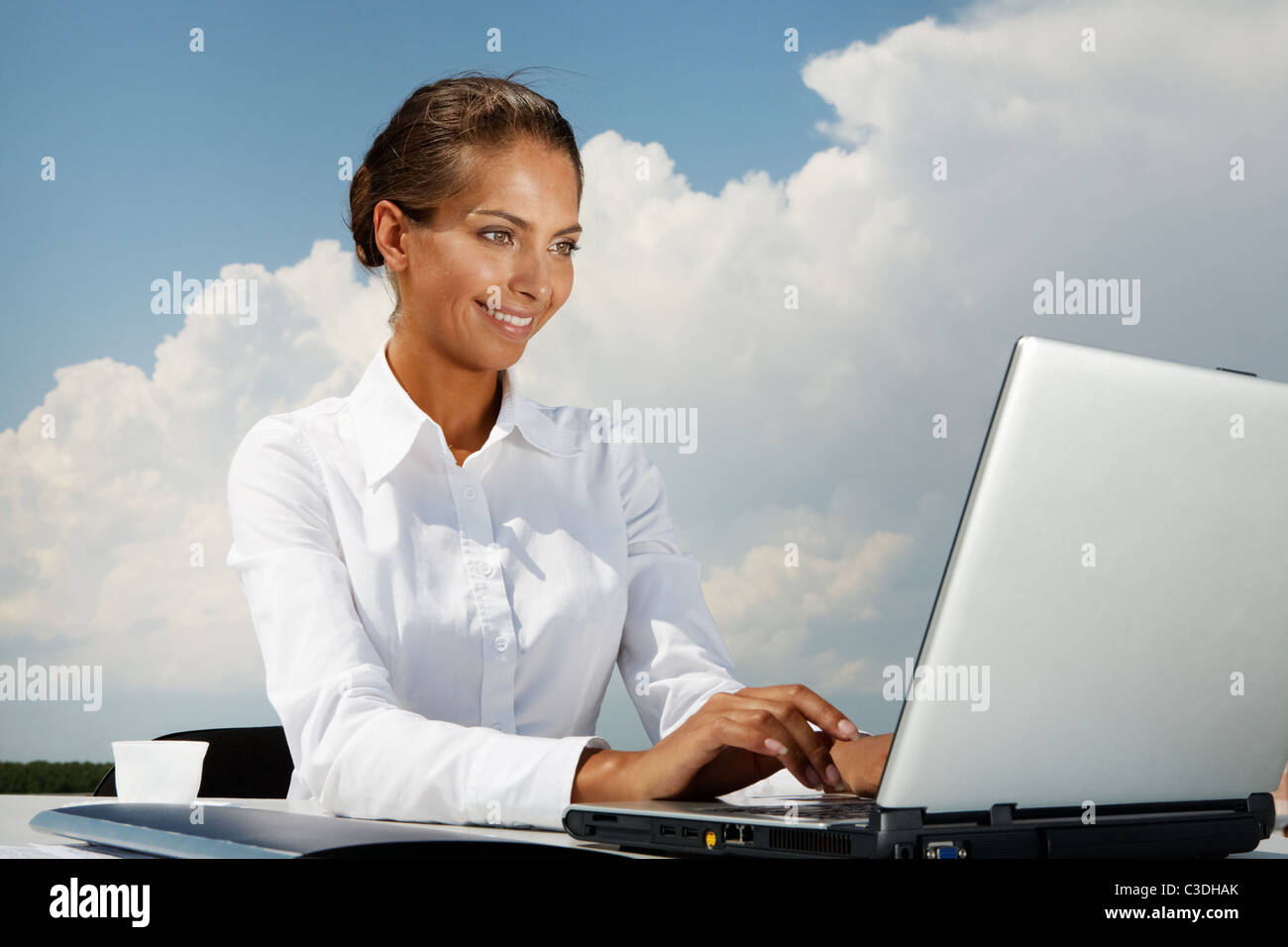 Portrait of smiling businesswoman typing a letter outside Stock Photo ...