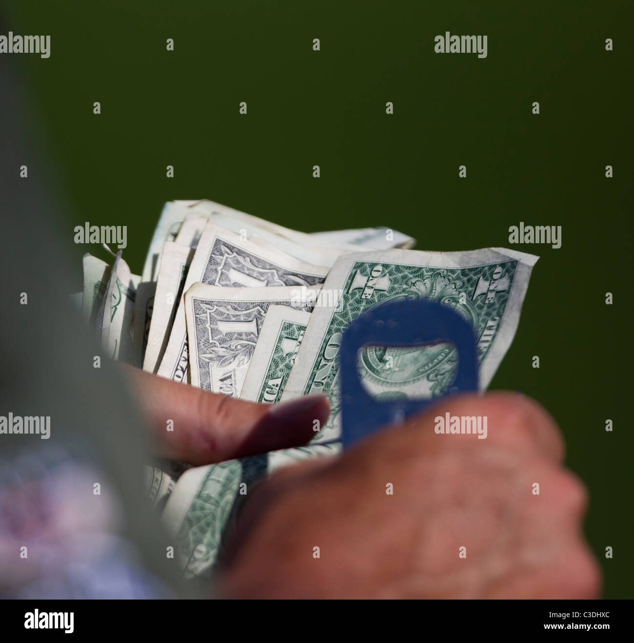 Dollar bills in a beer vendors hand Stock Photo - Alamy