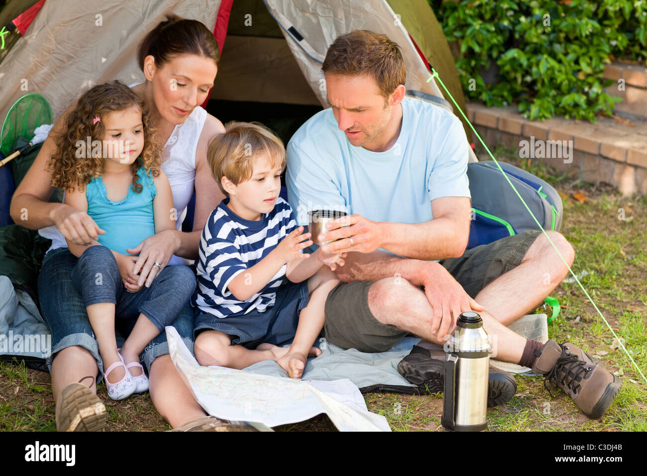 Adorable family camping in the garden Stock Photo - Alamy