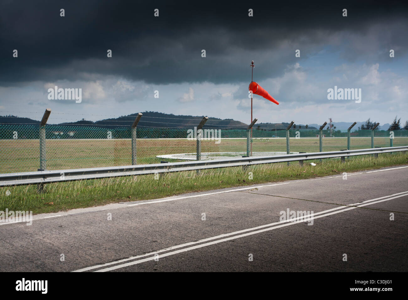red wind sock near an airport runway. Asia Stock Photo - Alamy