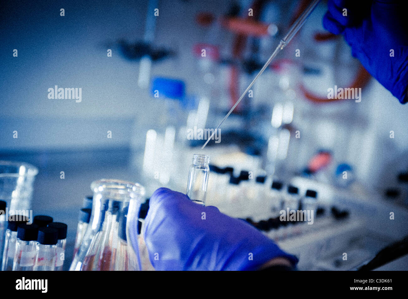 Close up of male scientist wearing white lab coat goggles and purple ...