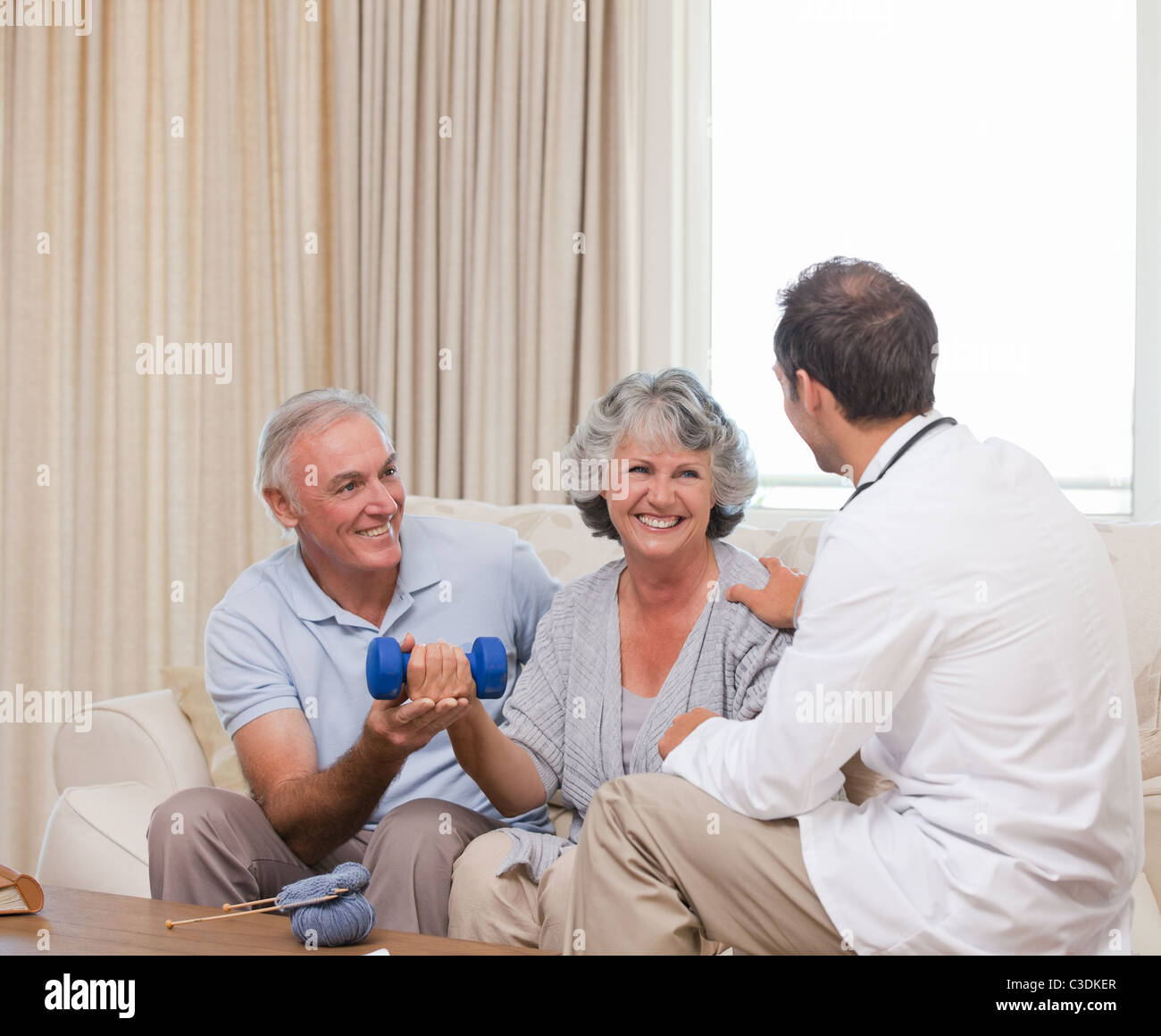 Handsome doctor helping his patient to do exercises Stock Photo - Alamy