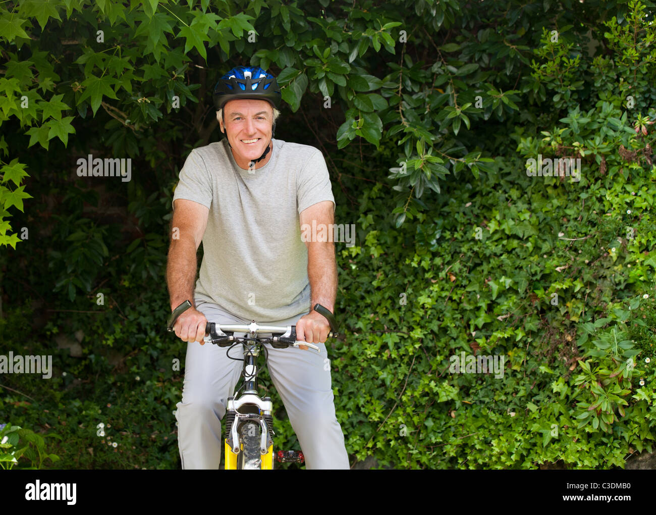 Mature man mountain biking outside Stock Photo - Alamy