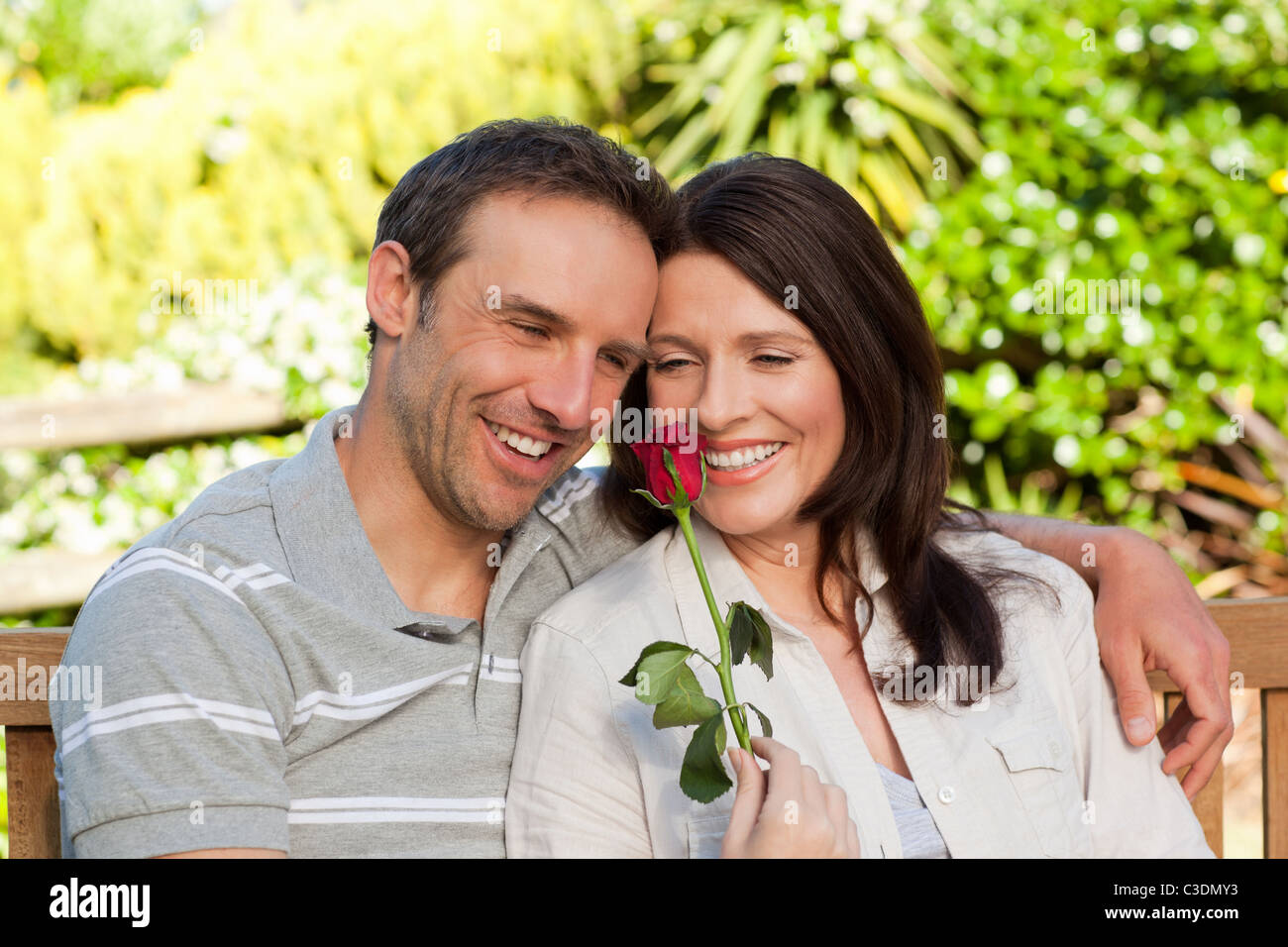 Lovely lovers in the garden Stock Photo - Alamy
