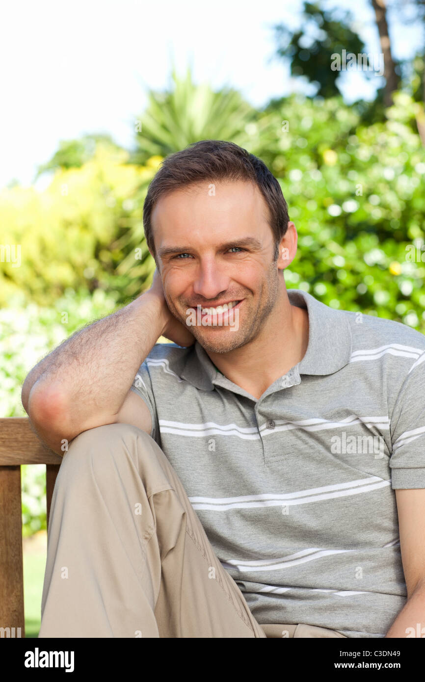 Portrait of a man sitting on a bench Stock Photo - Alamy