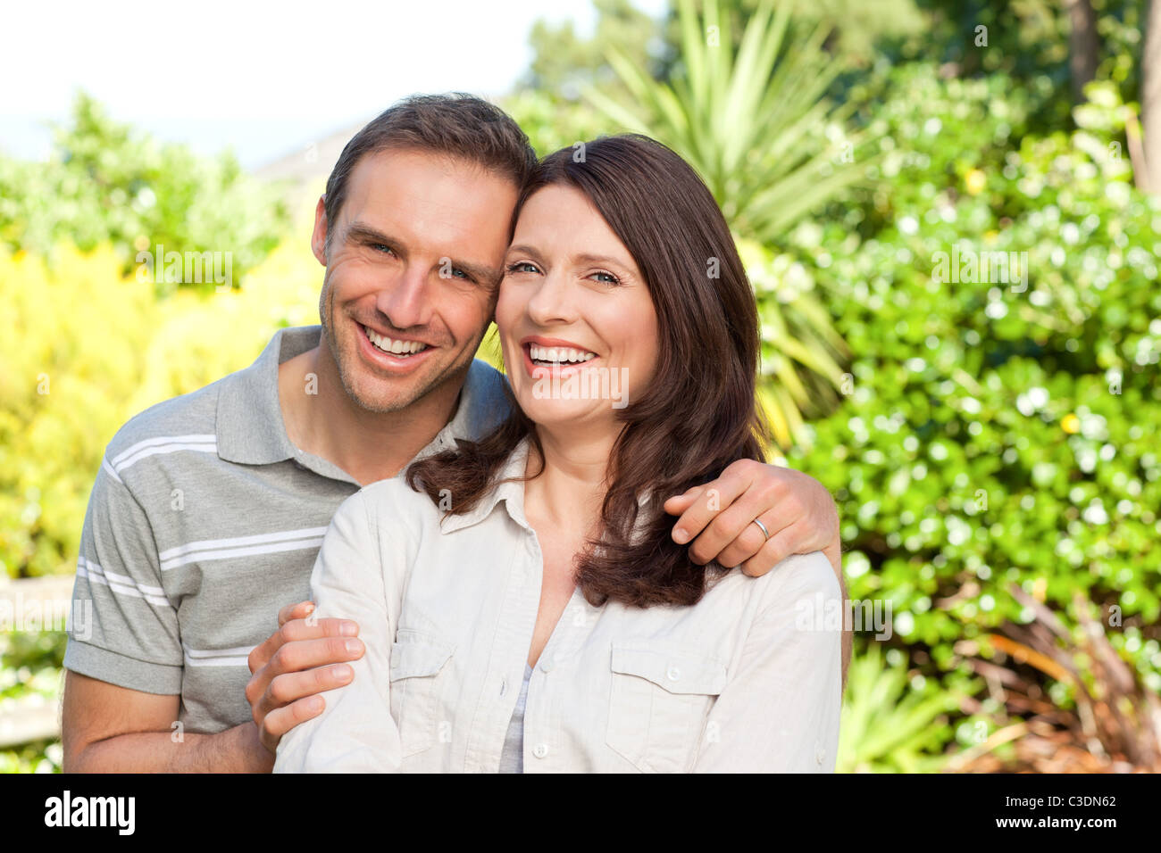 Beautiful woman with her husband in the garden Stock Photo - Alamy