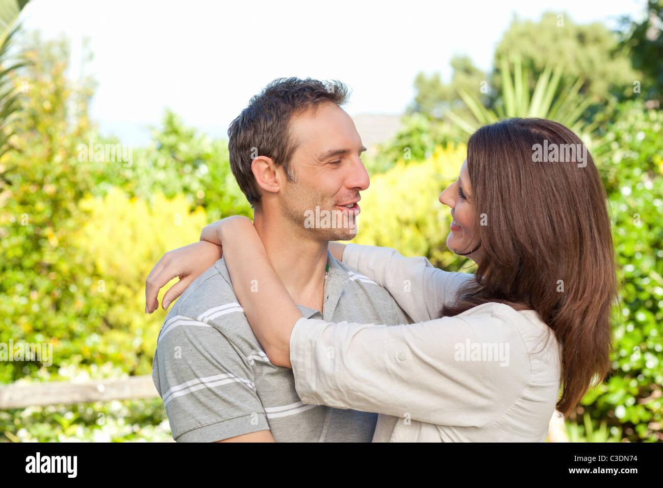 Enamored couple in the garden Stock Photo - Alamy