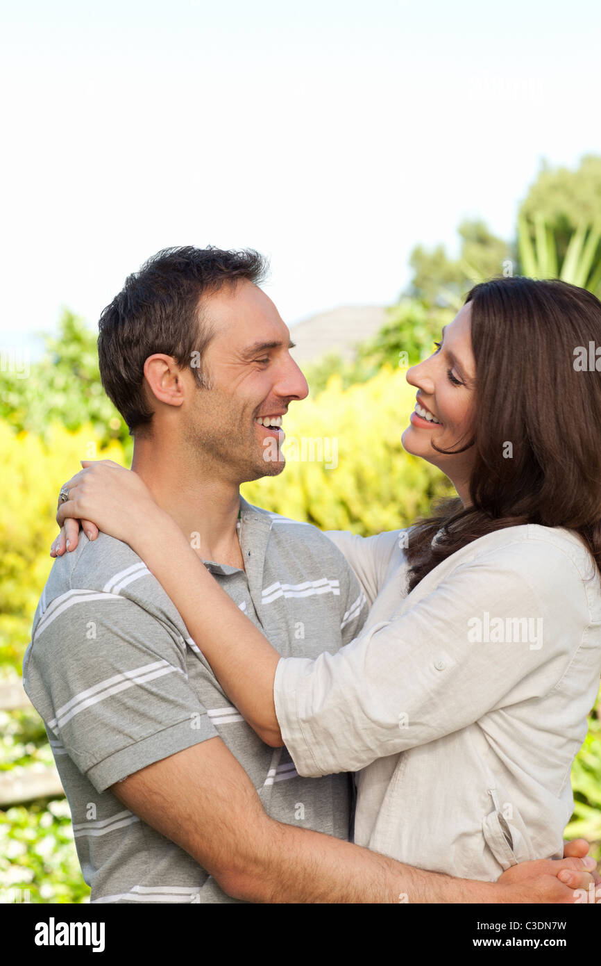 Enamored couple in the garden Stock Photo - Alamy