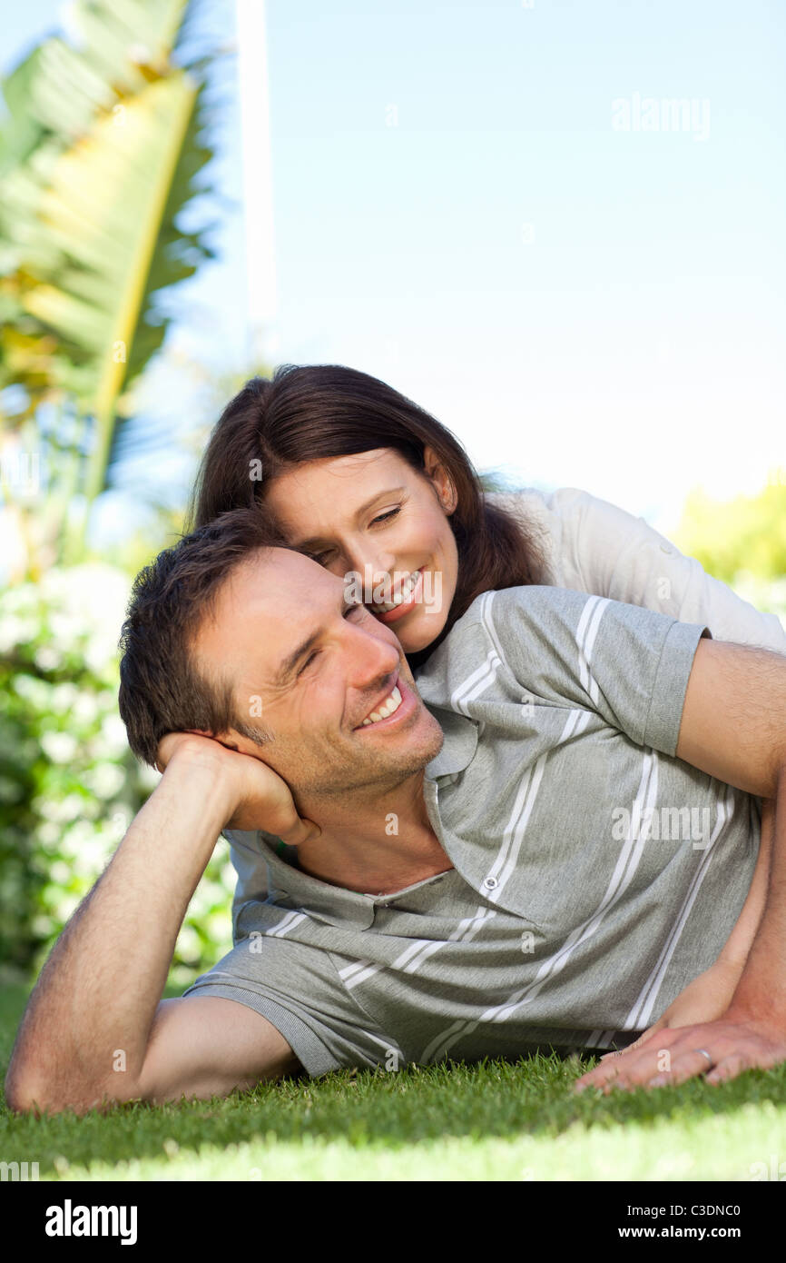 Couple lying down in the garden Stock Photo - Alamy