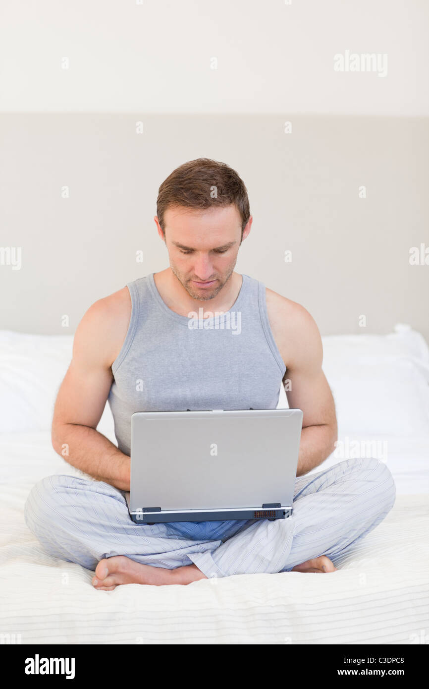 Man working on his laptop at home Stock Photo - Alamy