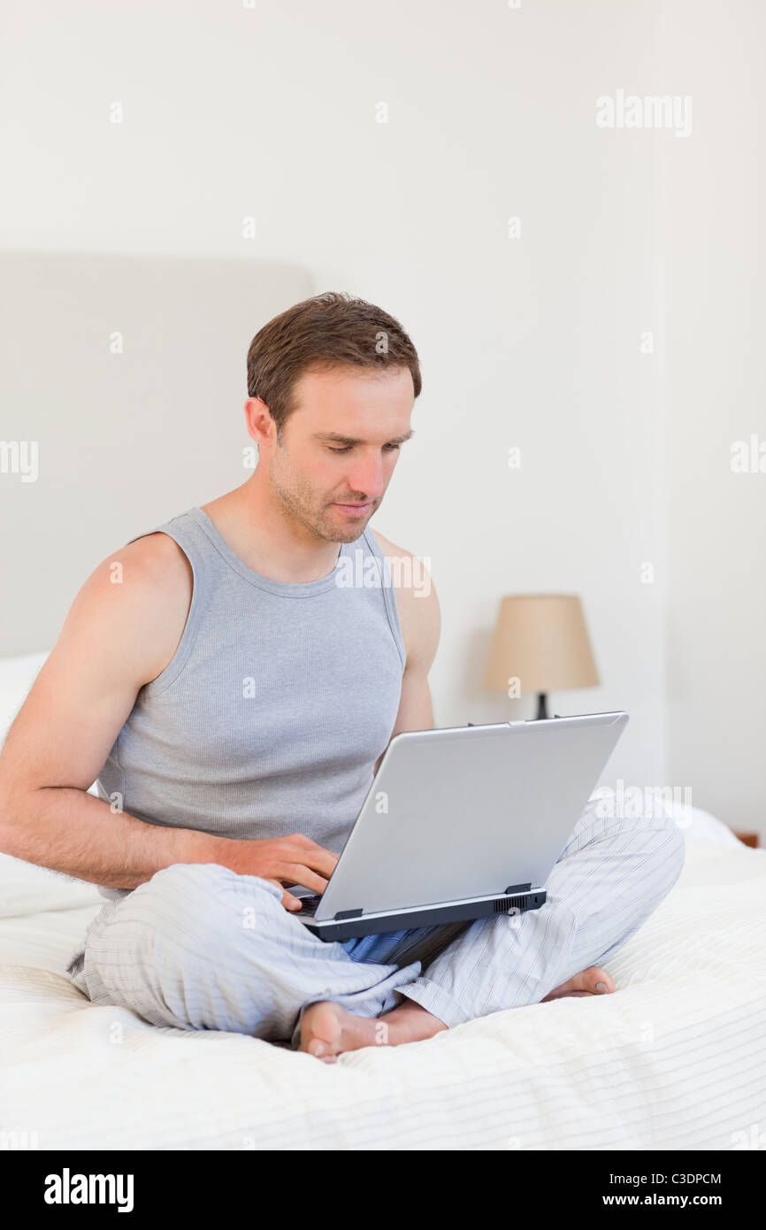 Man working on his laptop at home Stock Photo - Alamy