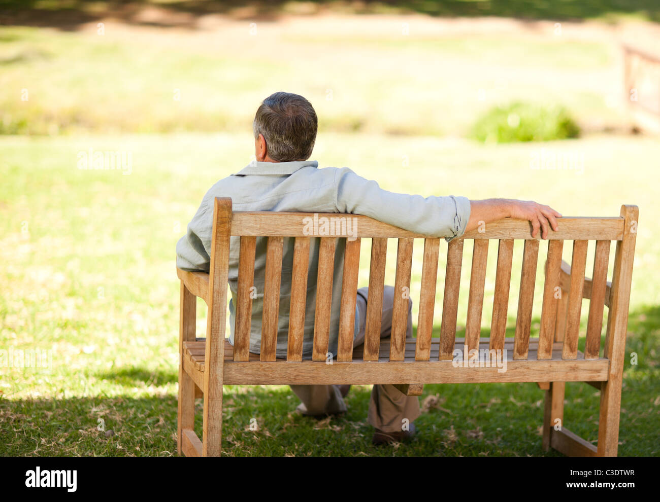 Elderly man sitting on the bench with his back to the camera Stock ...