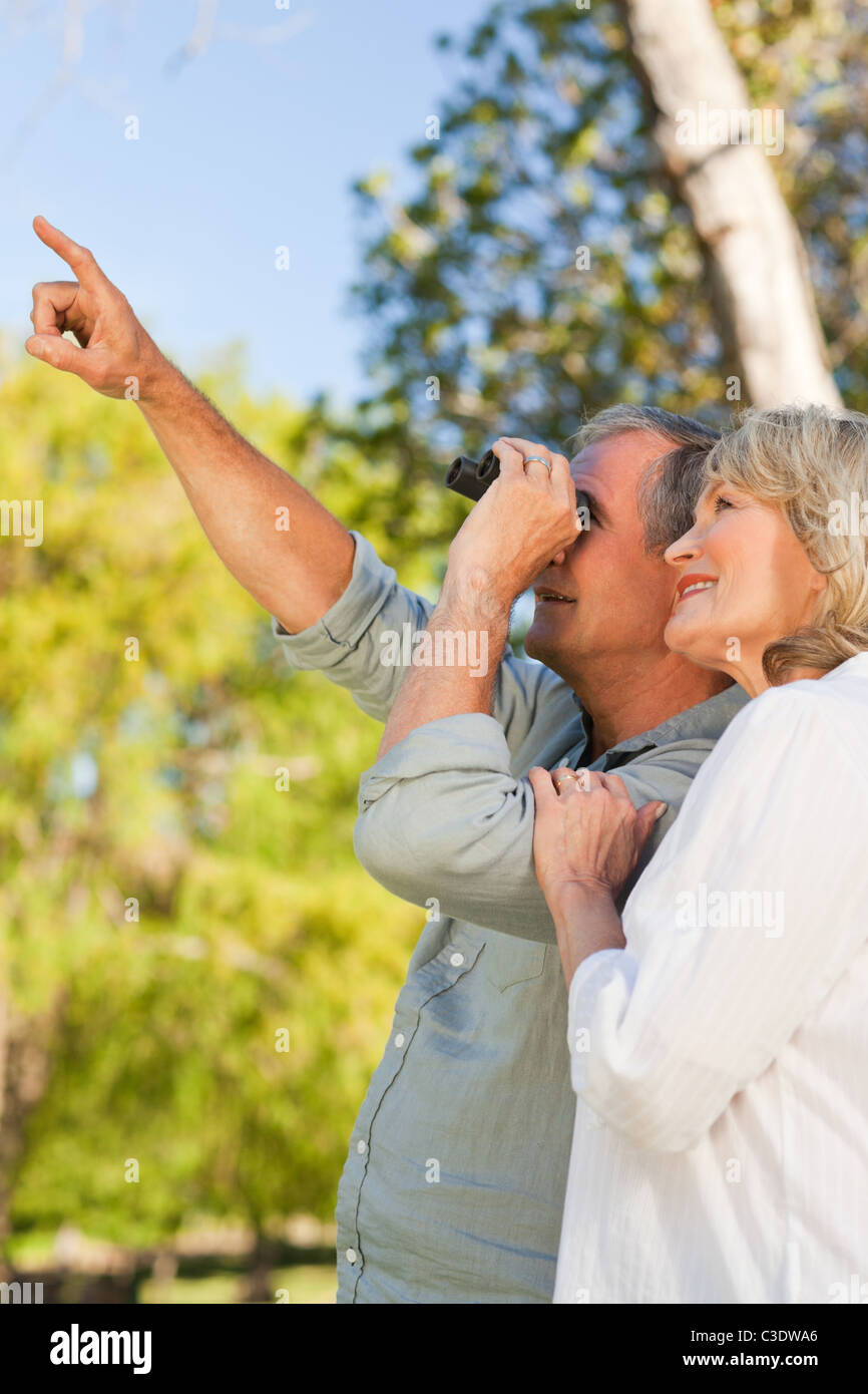 Couple looking at the sky with their binoculars Stock Photo - Alamy