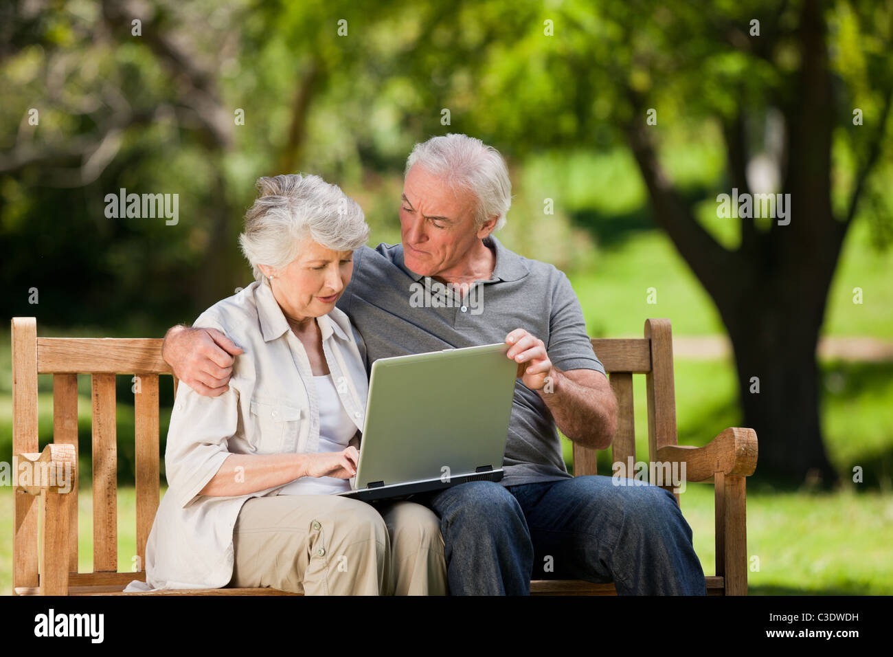Elderly couple looking at their laptop Stock Photo - Alamy