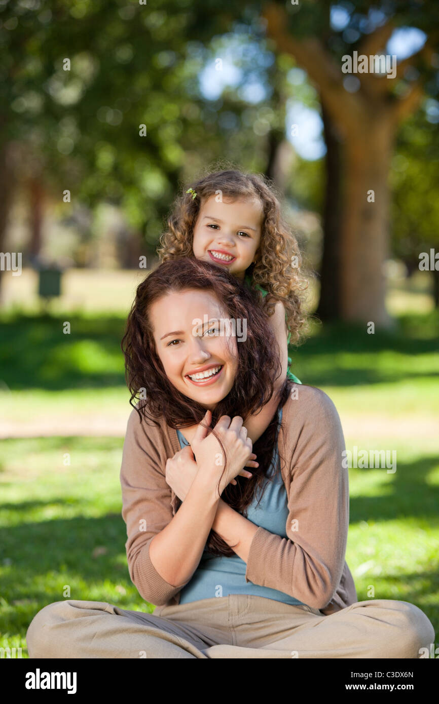 Woman hugging her daughter Stock Photo - Alamy