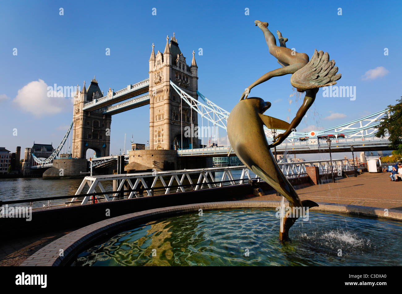Tower Bridge and Girl Playing With Dolphin statue, London, UK Stock ...