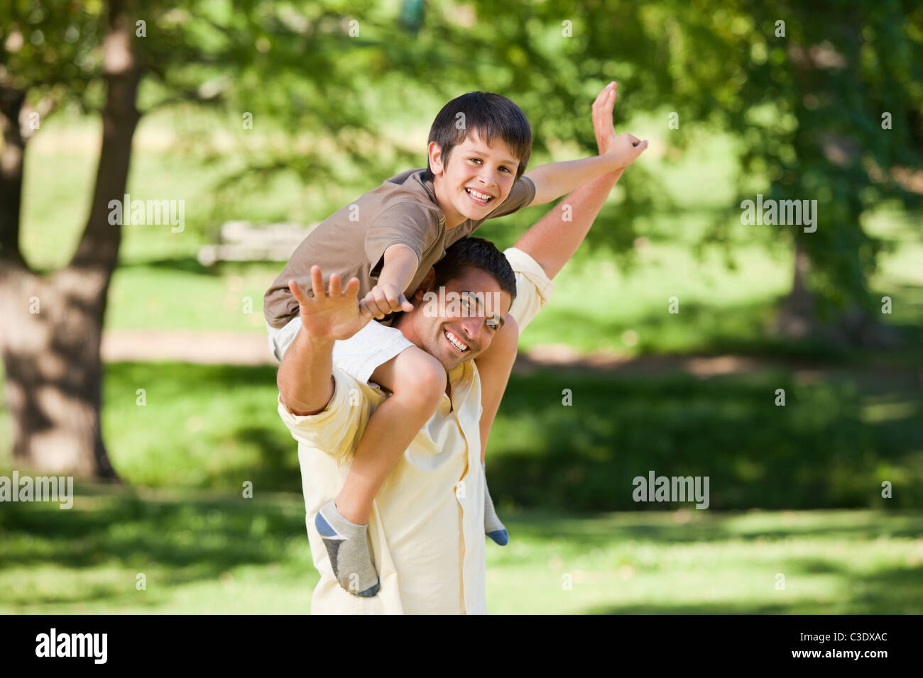 Handsome man giving son a piggyback Stock Photo - Alamy