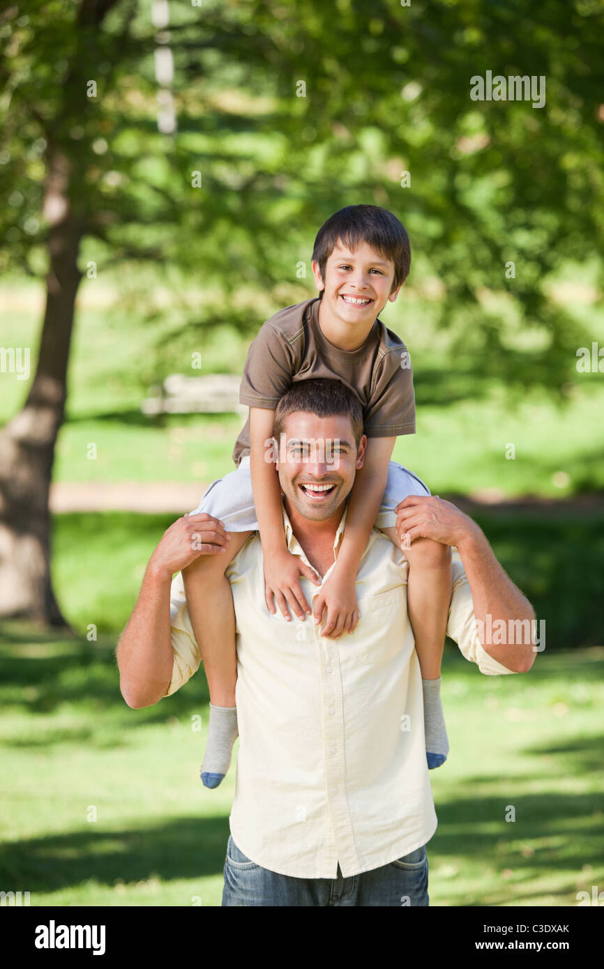 Handsome man giving son a piggyback Stock Photo - Alamy
