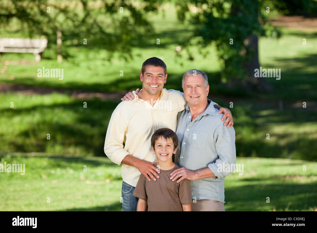 Family looking at the camera in the park Stock Photo - Alamy