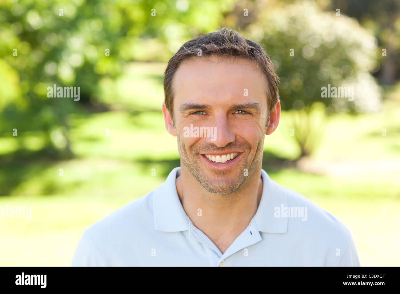 Man smiling in the park Stock Photo - Alamy