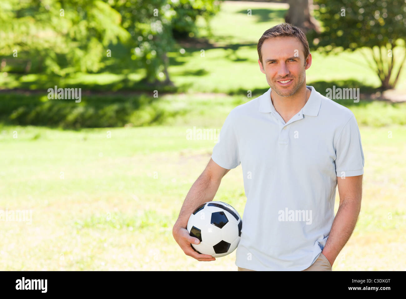 Handsome man with a ball Stock Photo - Alamy