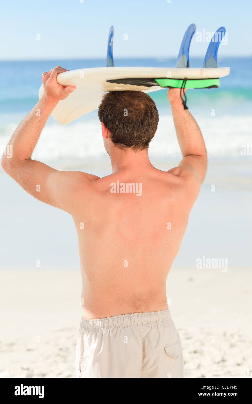 Handsome man with his surfboard Stock Photo - Alamy