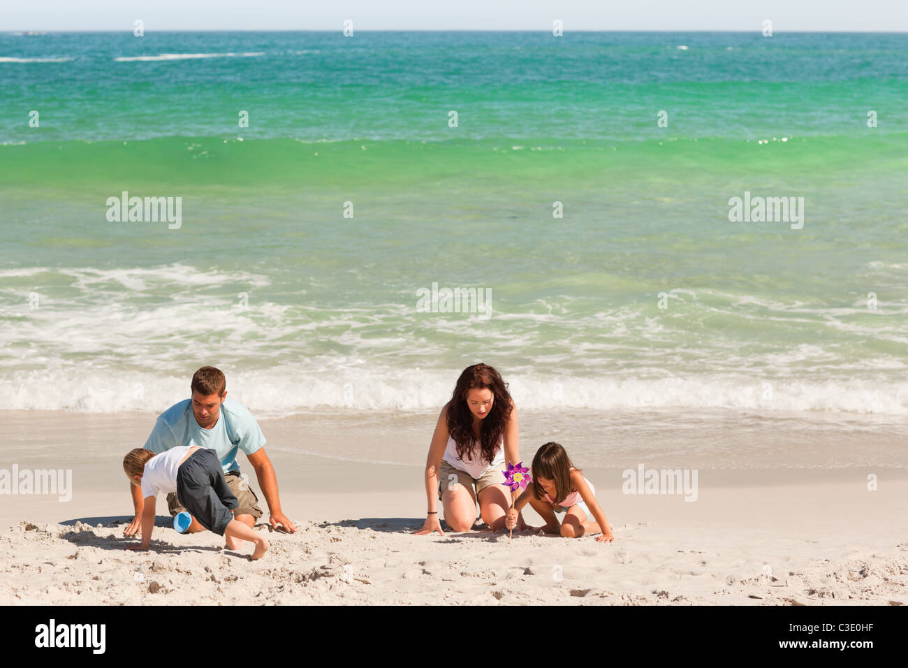 Family on the sand Stock Photo - Alamy