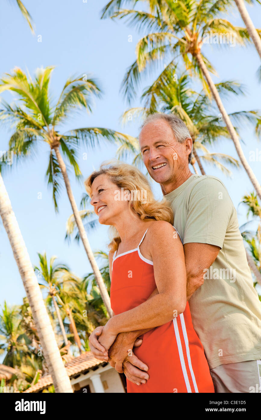 middle aged couple with palm trees Stock Photo - Alamy